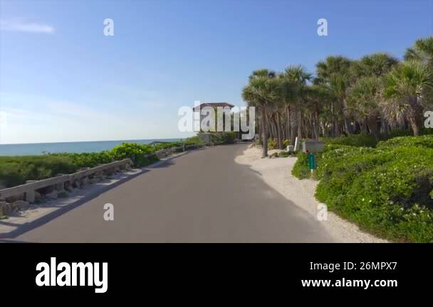 Florida travel concept. Car POV driving on Casey Key scenic road with ...