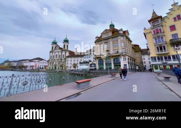 Pedestrian Reusssteg bridge across River Reuss observes the old town ...