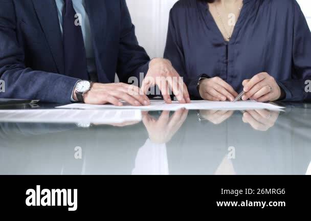 Business partners or lawyers are reviewing contract terms during a ...