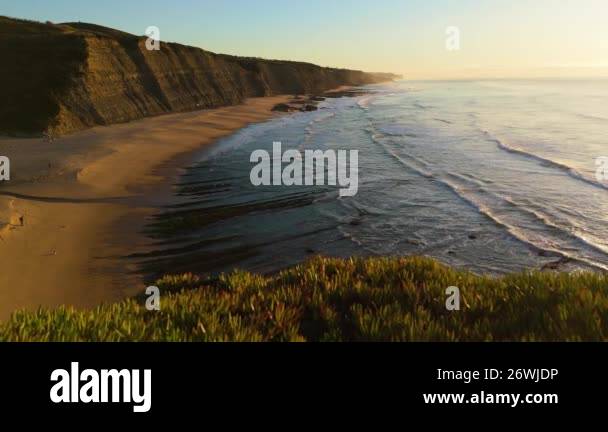 Magoito Beach and Cliffs at Sunset. Atlantic Ocean, Portugal. Golden ...