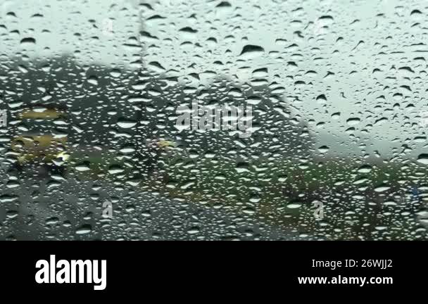 Outside view from inside of a car through the windscreen on a rainy day ...