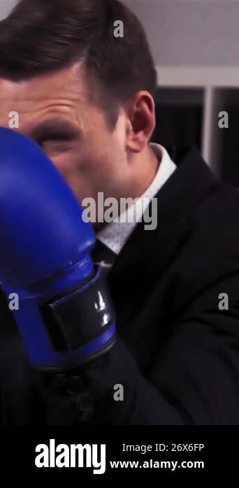 Two attractive Businessmen Boxing in Office Room. Red and blue gloves ...