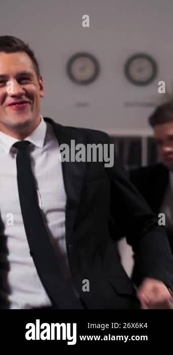 Three joyful employees expressive dancing cheerfully in office in front ...