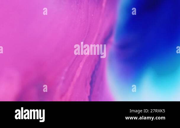 Vertical video. Paint splash. Fluid spill. Defocused neon pink blue ...