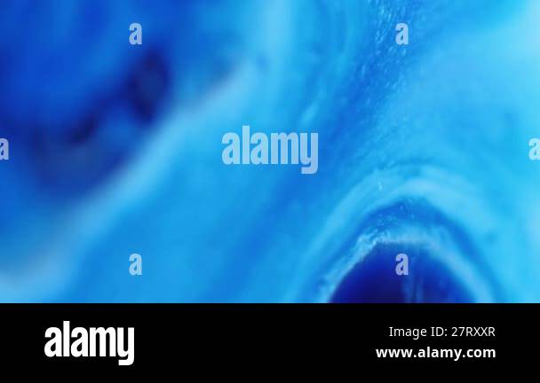 Ink drip. Liquid spill. Defocused blue color glowing acrylic emulsion ...