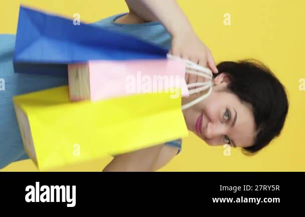 Vertical video. Exciting shopping. Retail therapy. Smiling woman happy ...