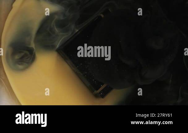 Smog spill. Paint water. Black yellow color mist dark shiny obsidian ...