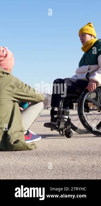 Wheelchair user and friend engaging in meaningful conversation, sharing ...
