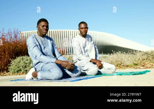 Two young senegalese men wearing traditional dashiki clothing are ...