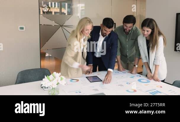 Creative team working on project strategy together, analyzing heap of ...