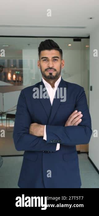 Confident attractive young Indian businessman vertical video portrait ...