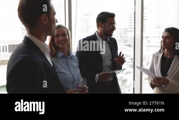 Four young professional multinational team lead conversation in office ...