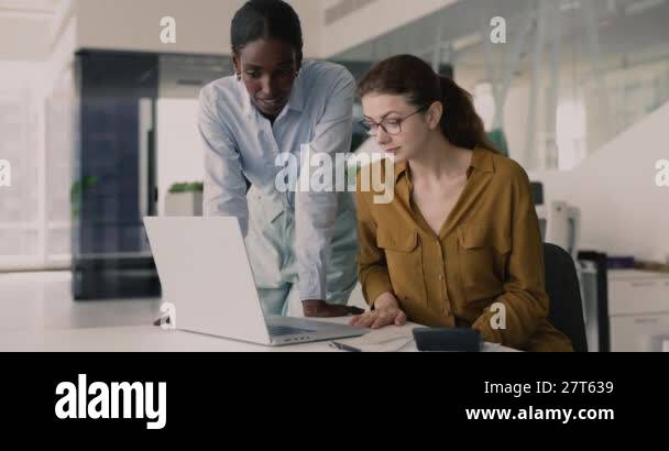 Two women teammates exchange friendly fist bump celebrating successful ...