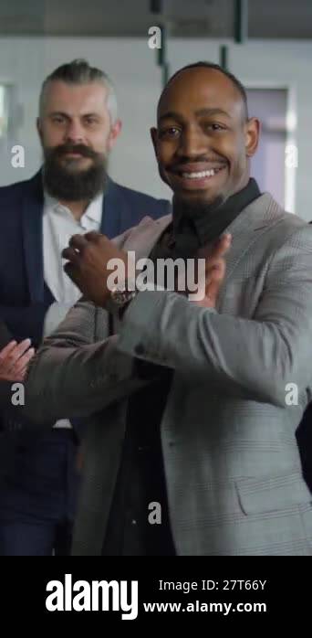 Vertical Screen: Confident and diverse group of business professionals ...