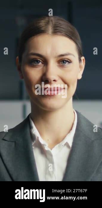 Vertical Screen: Close-up of a confident businesswoman smiling warmly ...
