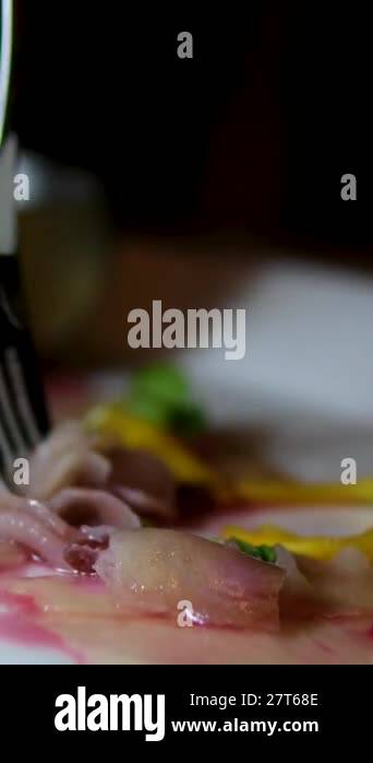 Woman mixing Sliced and chopped tuna fillet and spices in glass bowl ...