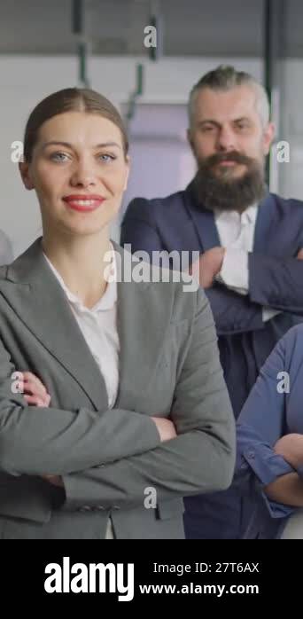 Vertical Screen: Group of confident business professionals standing ...
