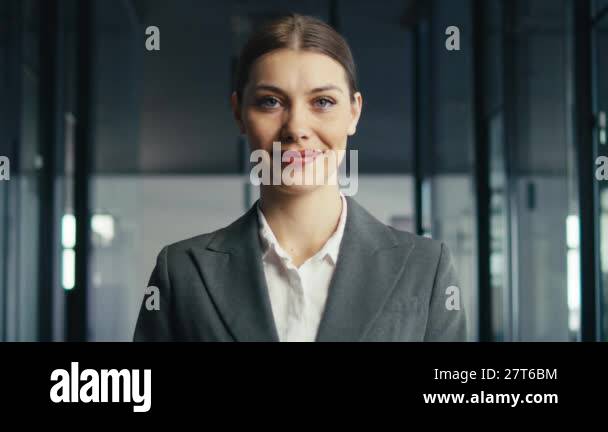 Close-up of a confident businesswoman smiling warmly in a corporate ...