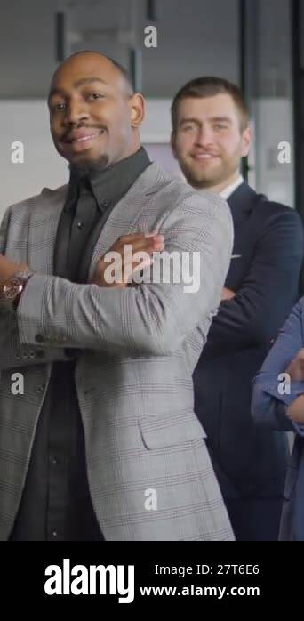 Vertical Screen: Confident team of diverse professionals in modern ...