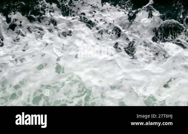 Sea waves with foam near the shore. Sea surface aerial view 4K ...