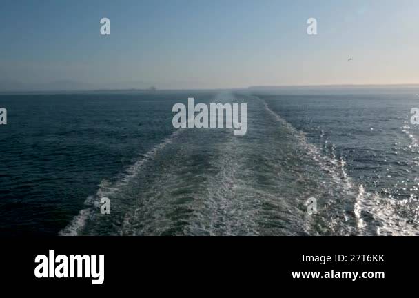 Wake of vessel. Wide wake trail from boat. Back view. Ocean water. Deep ...