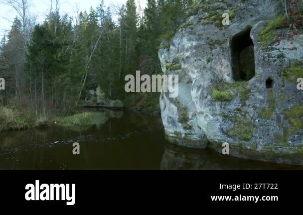Cliffs with Man-Made Caves on the Riverbank. A Cave or Cavern is a ...