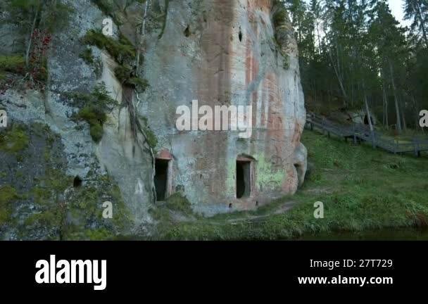 Cliffs with Man-Made Caves on the Riverbank. A Cave or Cavern is a ...