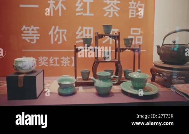Display of traditional tea sets in a cultural exhibition showcasing ...