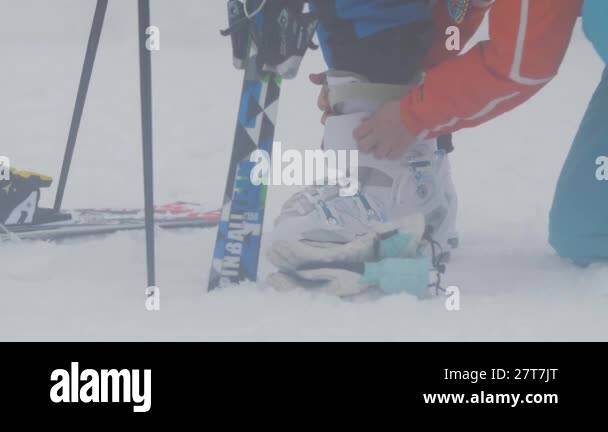 The Skier Tightens His Ski Boots. It's Snowing Hard. You Can Learn to Ski by Starting from a ...