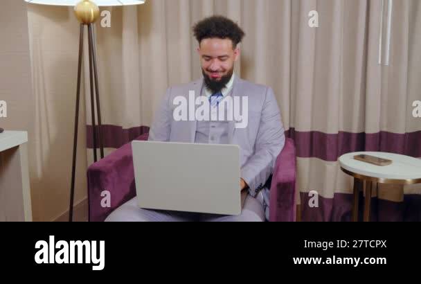 A welldressed and sophisticated businessman is seated comfortably in a ...