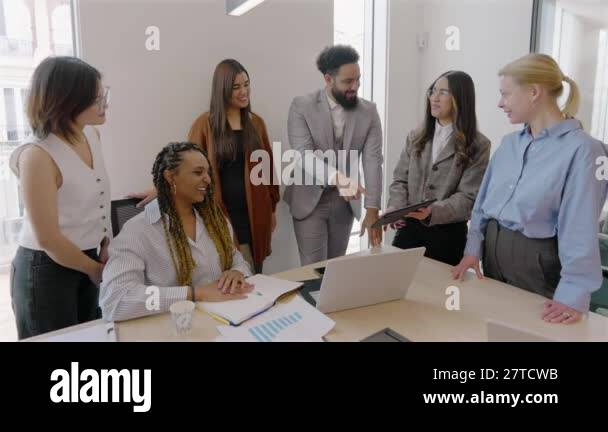 Diverse and dynamic group of ambitious business professionals is actively collaborating in a ...