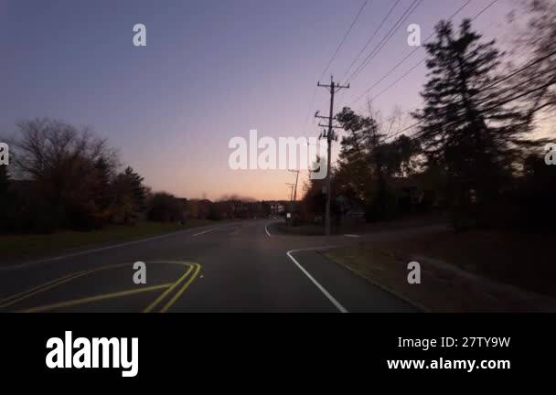 Driving on the road at sunset or sunrise time. Wide POV wide shot shot ...