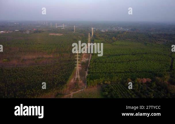 Aerial view of high voltage electric poles and power lines at green ...