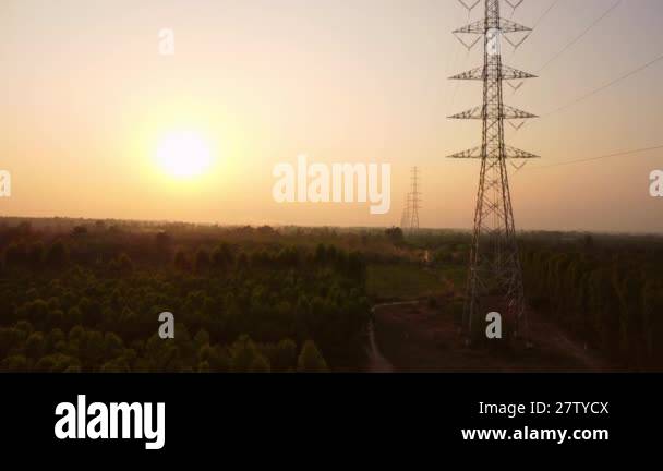 Aerial view of high voltage electric poles and power lines at green ...