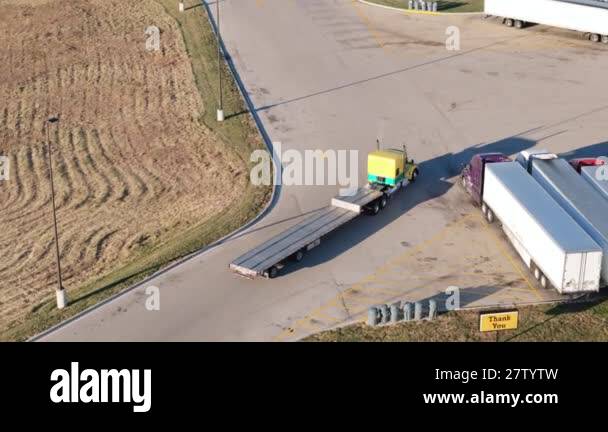 Aerial view of the truck with step deck trailer is moving on truck stop ...
