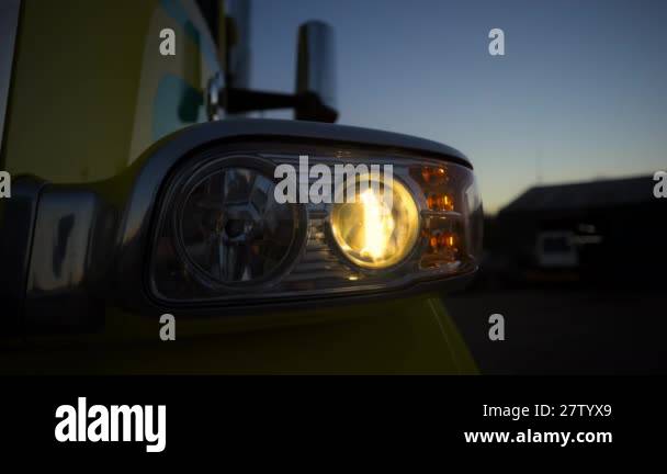 Semi truck Headlights in the parking lot at evening time. Move camera. High quality 4k footage ...