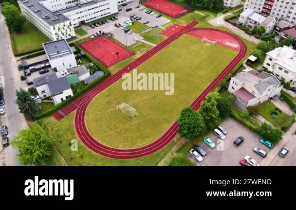 Aerial view of a sports complex with a running track, soccer field, and ...