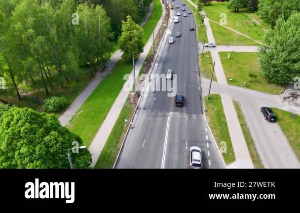 Aerial view of a road with cars and an ambulance vehicle, surrounded by ...
