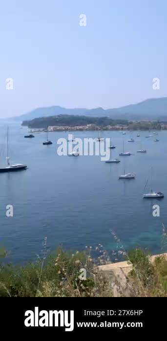 A stunning view of Corfu Island, Greece, showcasing a serene bay filled ...