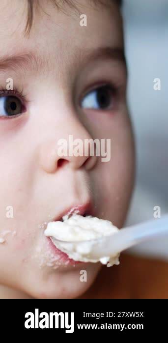 Sweet cute baby face smeared with food. Portrait of a little toddler ...