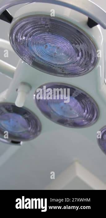 Switched off lamps on the ceiling of contemporary surgery room. Low ...