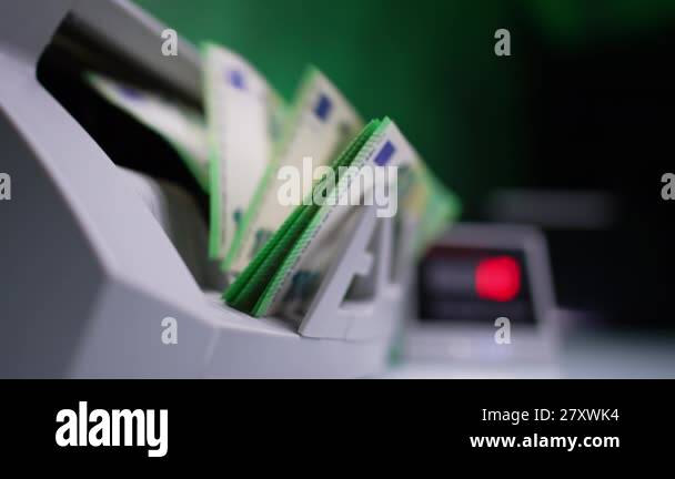 Starting electronic cash counting machine. Side view. Green one hundred ...