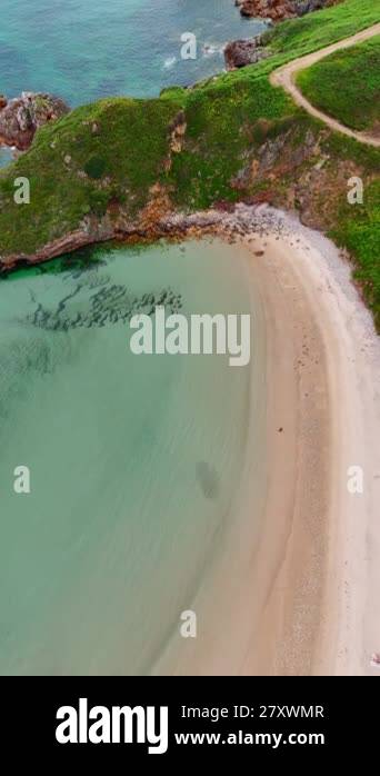 Flight over the sandy beach and clear turquoise water. Rocks covered ...