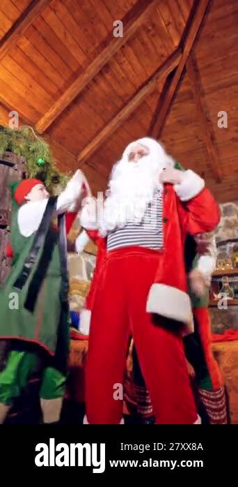 Santa Claus is wearing his costume in specially decorated room in his ...