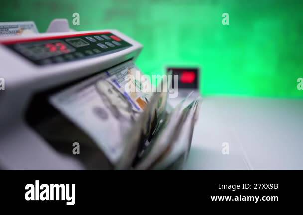 Banknotes with Benjamin Franklin counted in money counting machine ...