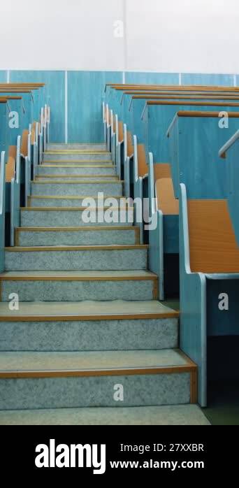 Empty auditorium. Stairs between two rows of desks in conference hall ...