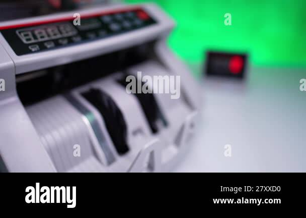 Cash counting machine is switched on. American one hundred dollars are ...