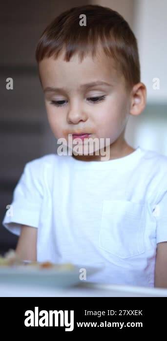 Lovely toddler boy in white t-shirt with smudged face. Portrait of a ...
