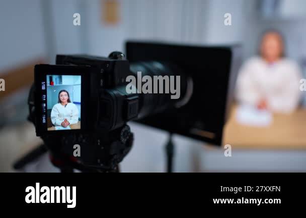 Display of camera showing the female presenter speaking. Blogging and ...