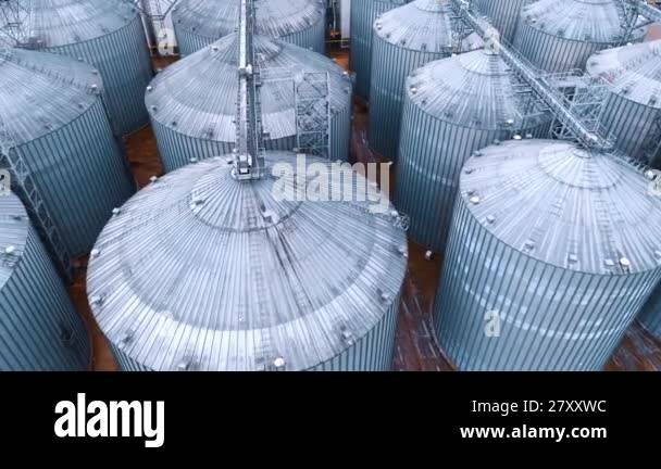 Flight over the huge cone tops of the metal tanks. Elevators of the ...